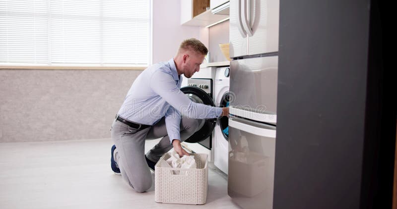 Man Loading Clothes into Washing Machine Stock Image - Image of ...