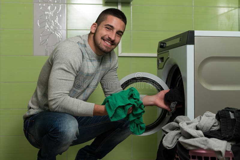 Young Man Loading the Washing Machine in Room Stock Image - Image of ...