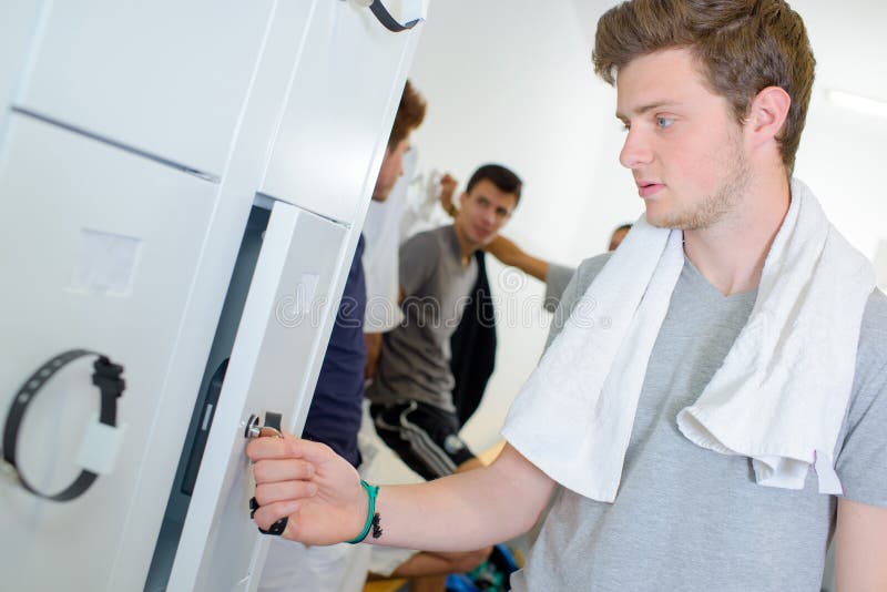 Young man in locker room stock photo. Image of practice - 249438090