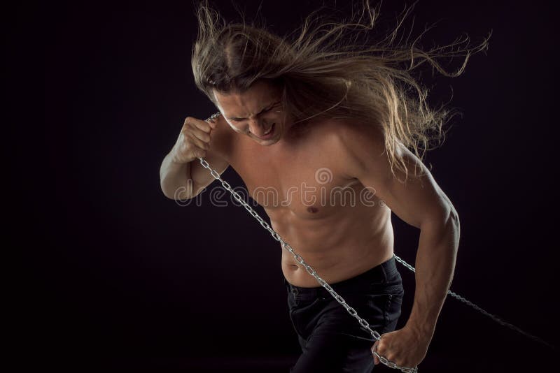 Young Man with Long Hair Dragging Something Behind Him. Strong. Stock ...