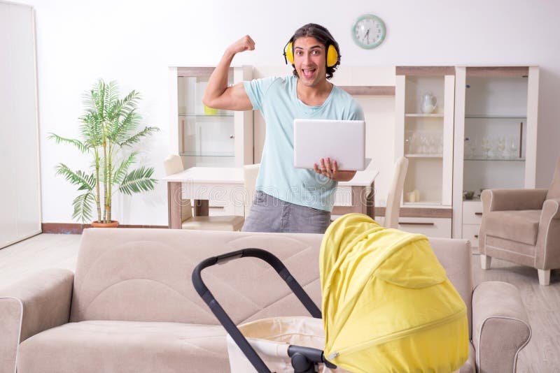 Young Man Looking after Baby in Pram Stock Photo - Image of earmuffs ...