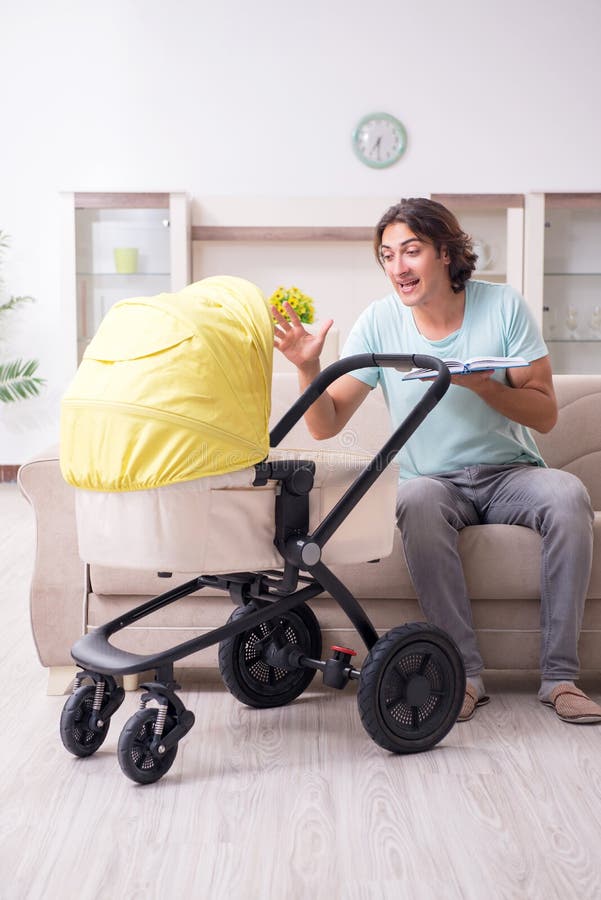 Young Man Looking after Baby in Pram Stock Photo - Image of care, leave ...