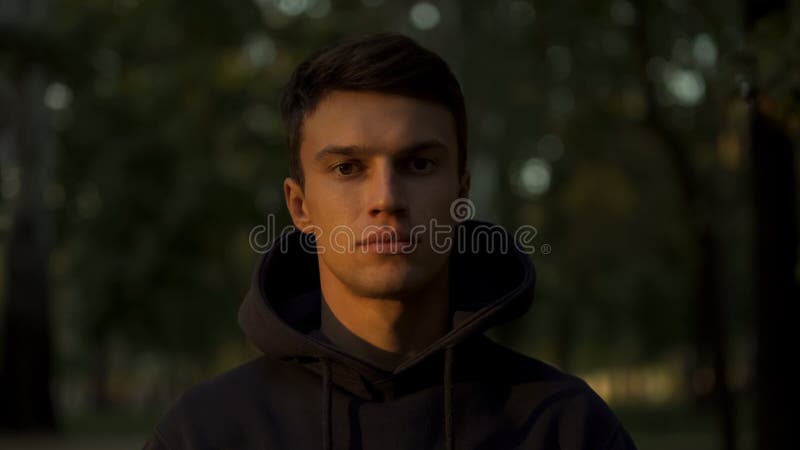 Young Man Looking at Camera, Half Shadowed Face, Good and Evil Fight ...