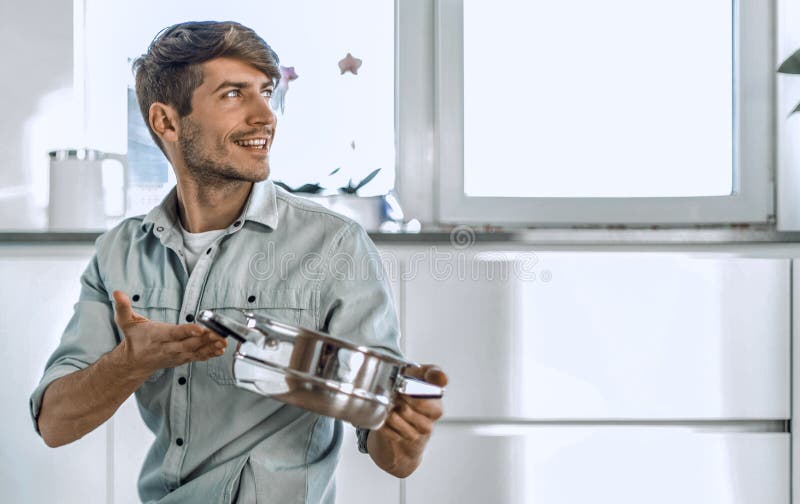 Young Man Looking at Clean Dishes in Dishwasher Stock Photo - Image of ...