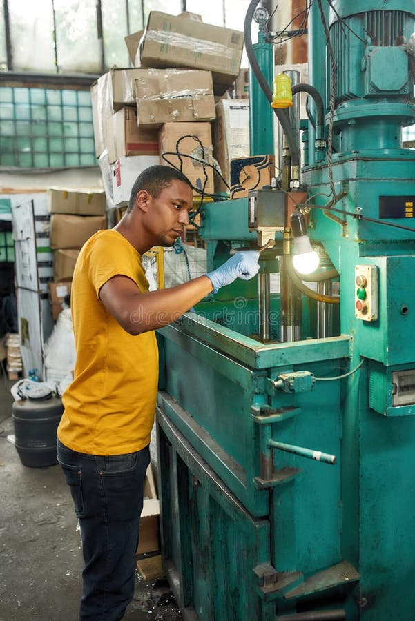 Young Man Looking into Compression Machine on Waste Station Stock Photo ...