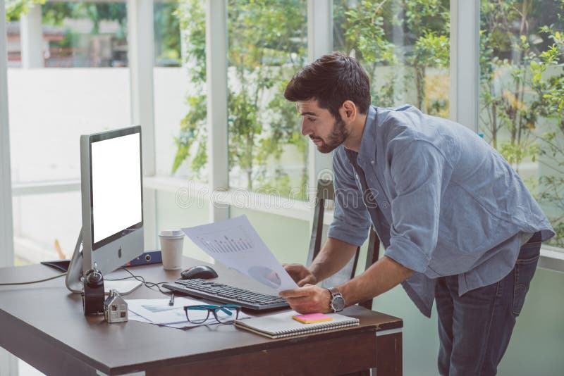 Young Man Looking the Documents and Computer. Working from Home Concept ...
