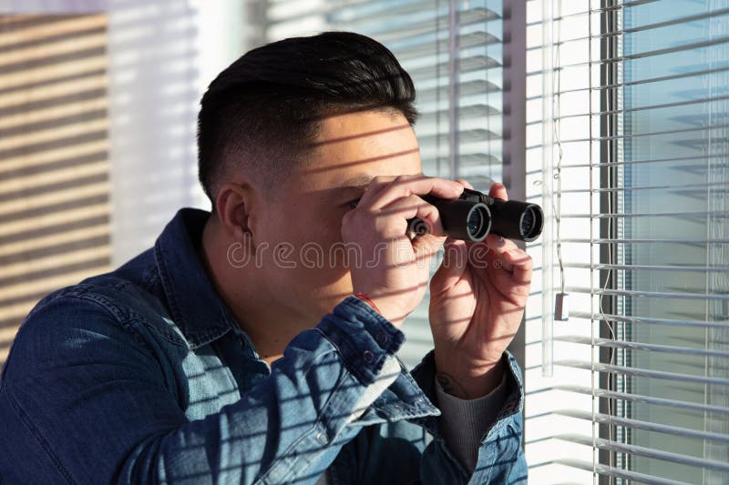 Young Man Looking through Glass Window with Binoculars Stock Image ...