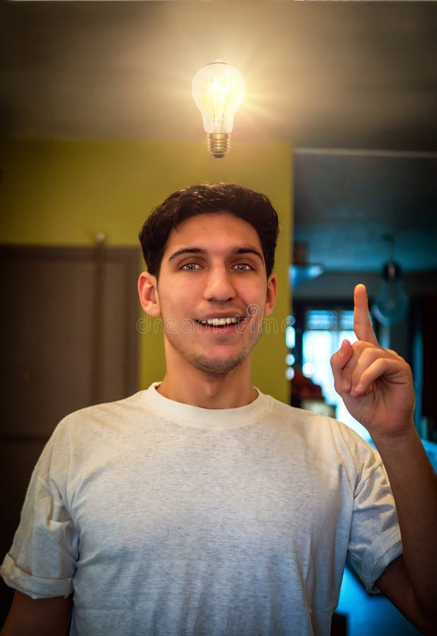 Young Man Looking at Lit Up Lightbulb. Idea, Enlightment Concept Stock ...