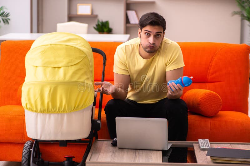 Young Man Looking after New Born at Home Stock Image - Image of taking ...
