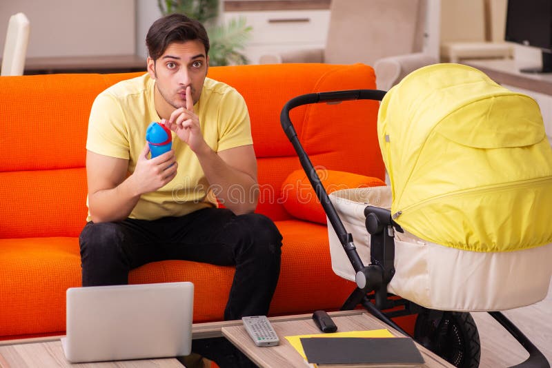 Young Man Looking after New Born at Home Stock Image - Image of ...