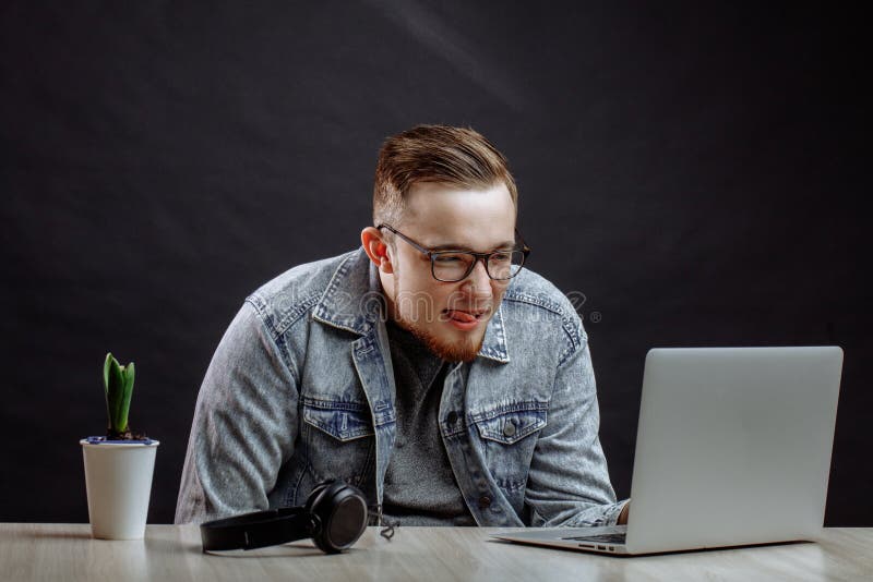 Young Man Looking at the Screen of the Notebook and Smacking His Lips ...