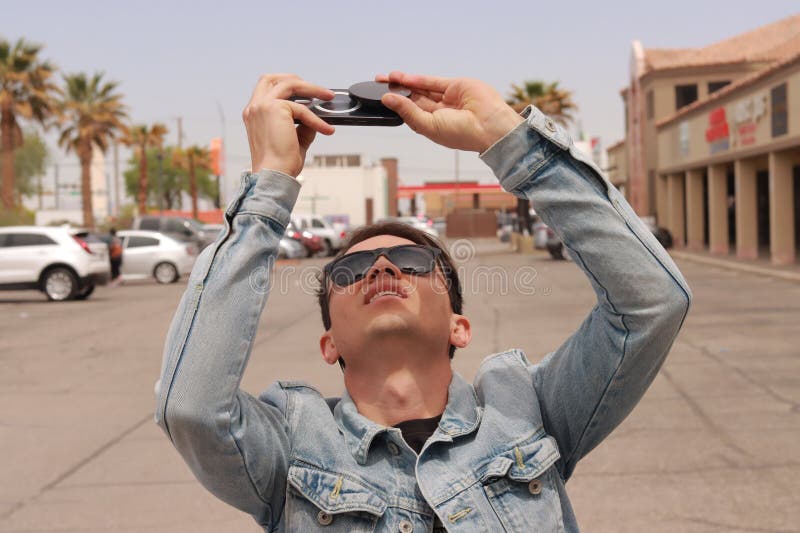 Young Man Looking at the Sun and Taking Photos during a Solar Eclipse ...