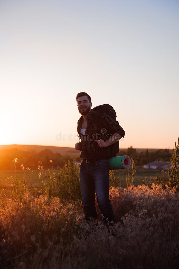 Young Man is Looking at Sunset. Traveller with Backpack Stock Image ...