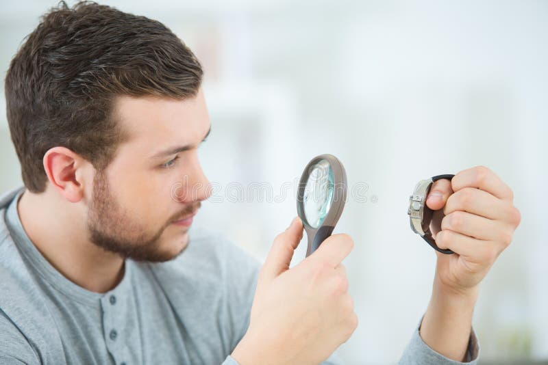 Young Man Looking at Watch through Magnifying Glass Stock Photo - Image ...