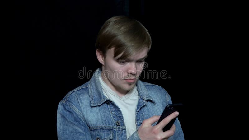 Young Man Looks at Phone. Message Came on Phone Stock Image - Image of ...