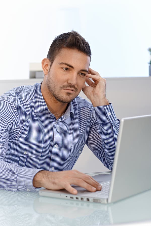 Young man lost in work stock image. Image of focusing - 31473621
