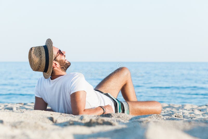 Young Man Lying on the Beach Stock Photo - Image of chilling, beach ...