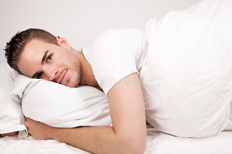 Young man lying in bed stock image. Image of cover, calm - 30678699