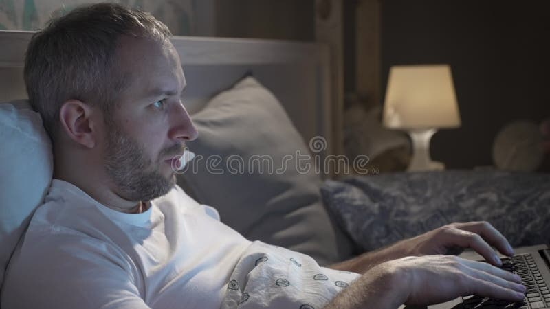 Young Man Lying in the Bed with Laptop and Sleeping Stock Video - Video ...