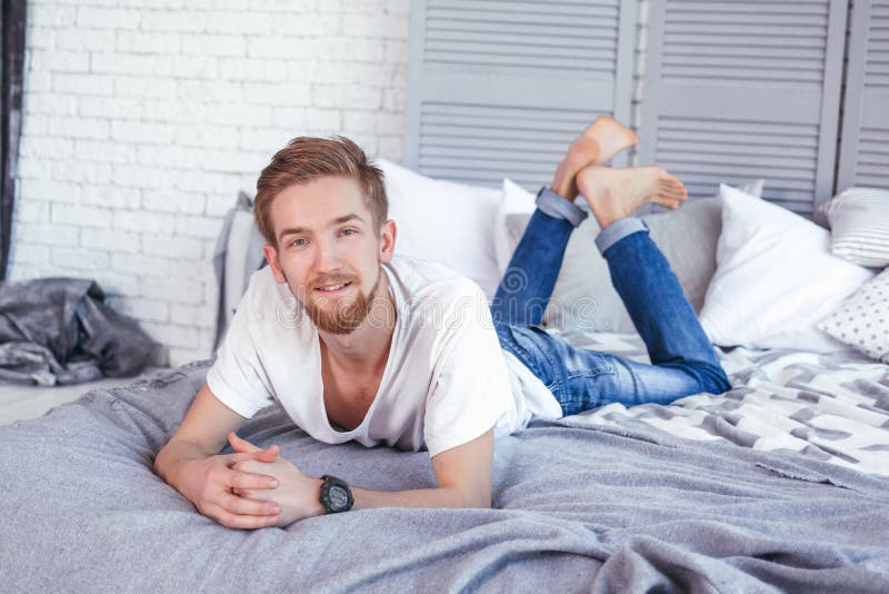 Young man lying in bed stock image. Image of rest, awake - 115046947