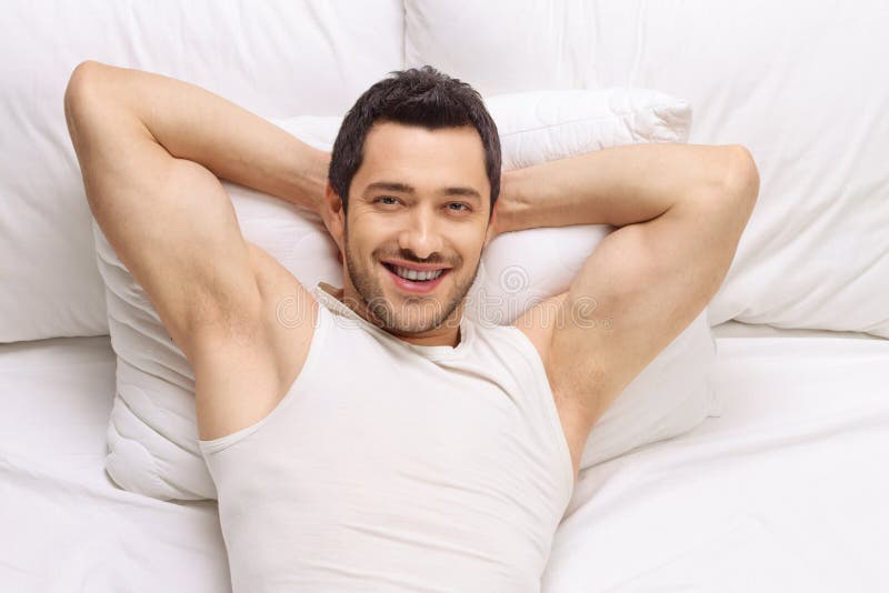 Young Man Lying in a Bed and Smiling Stock Image - Image of relax, good ...