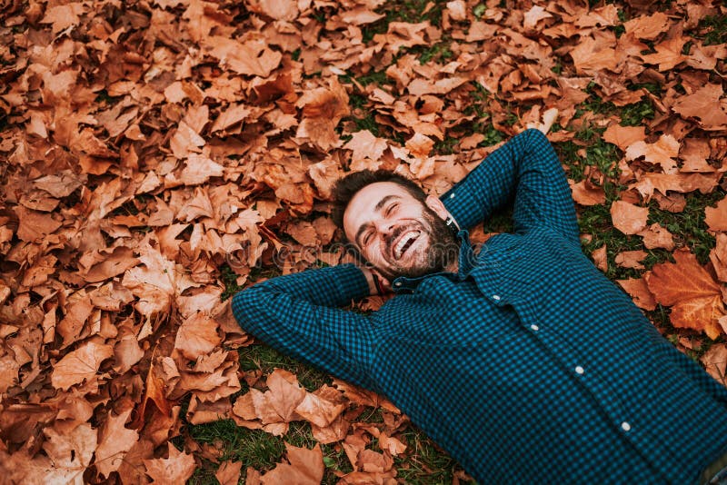 Young Man Lying Down on Autumn Leaves Stock Photo - Image of happiness ...