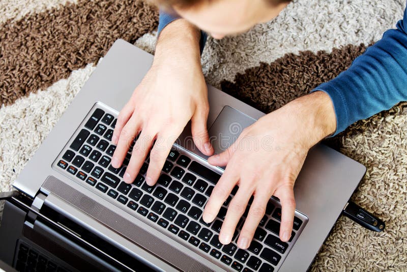 Young Man Lying on the Floor and Using Laptop Stock Photo - Image of ...