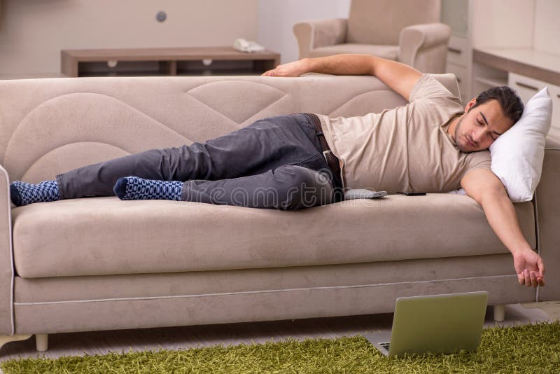 Young Man Lying on the Sofa at Home Stock Photo - Image of lockdown ...