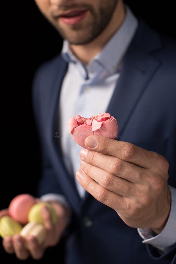 Young man with macaroon stock image. Image of enjoying - 84063787