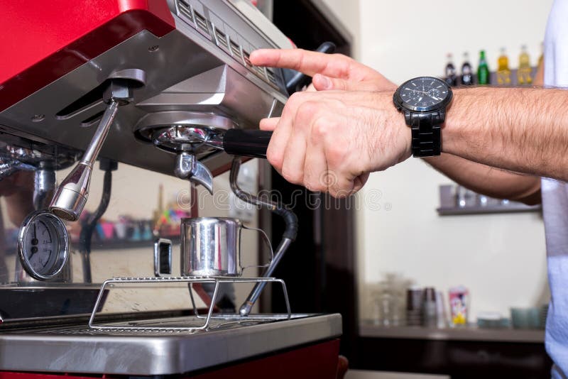 Young man making coffee stock image. Image of metallic - 141586105