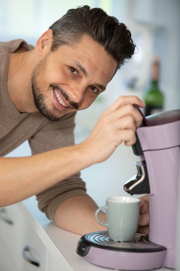 Young Man Making Coffee in Kitchen Stock Photo - Image of coffeemaker ...