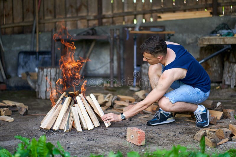 Young Man Making a Fire for Bbq Stock Image - Image of firewood, energy ...