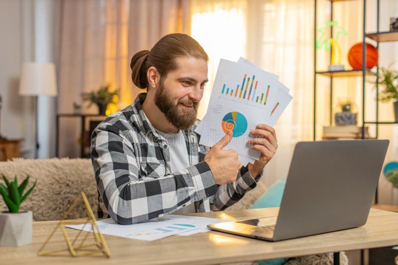 Young Man Making Laptop Video Chat at Home Table Showing Paperwork ...