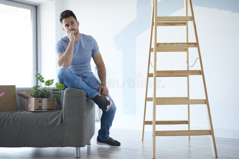 Young Man Making Plans for His New Flat Stock Photo - Image of making ...