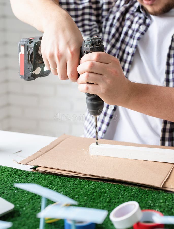 Young Man Making Renewable Energy Project Dummy Using Drill Stock Photo ...