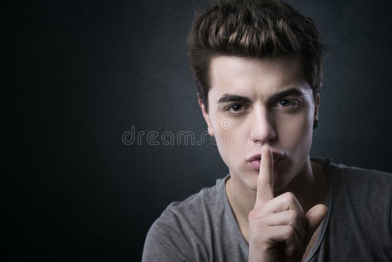 Young Man Making Silence Gesture Stock Photo - Image of portrait ...