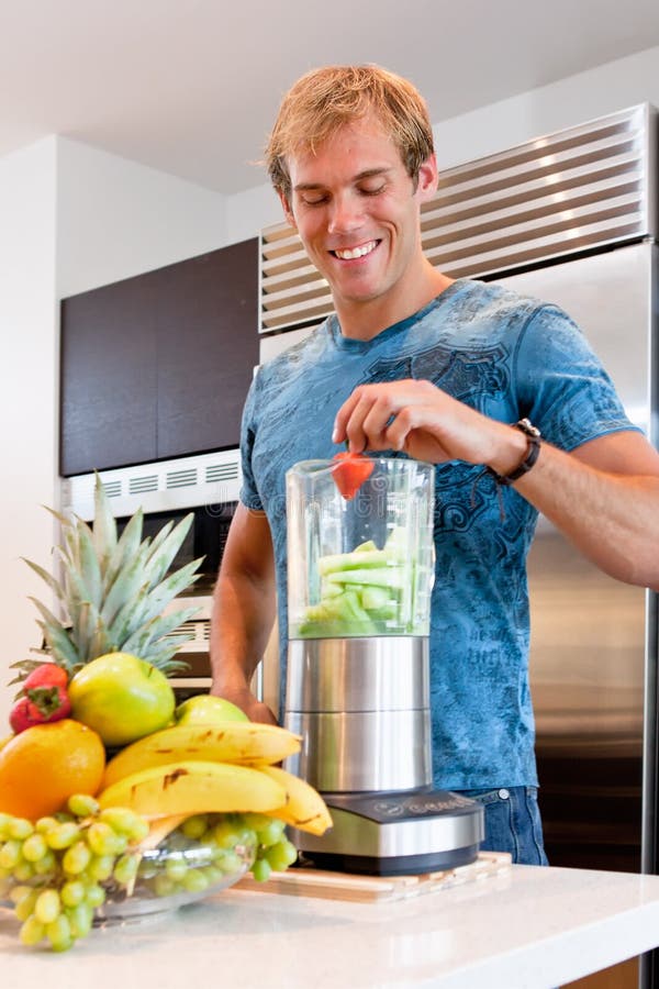 Young Man Making a Smoothie Stock Photo - Image of nutritious, mixed ...