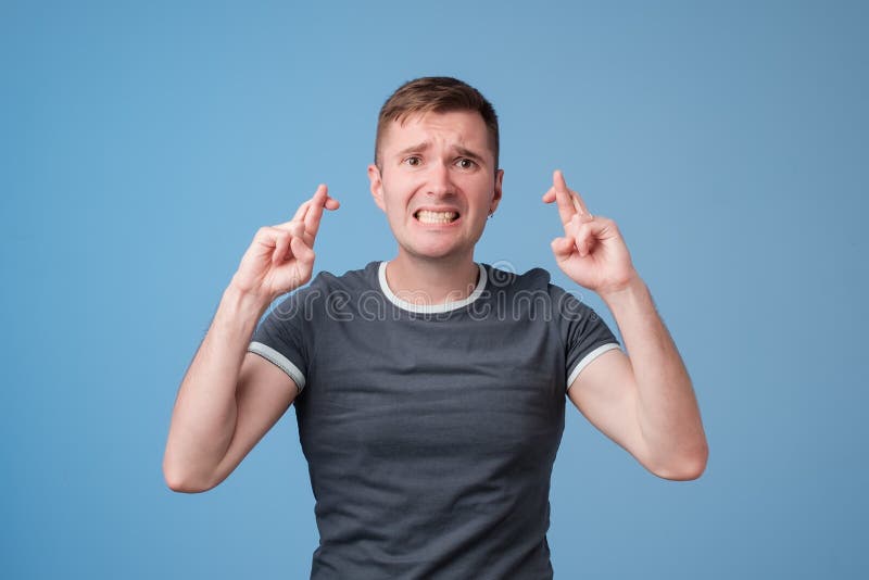 Young Man Making a Wish Isolated on Blue Background Stock Image - Image ...