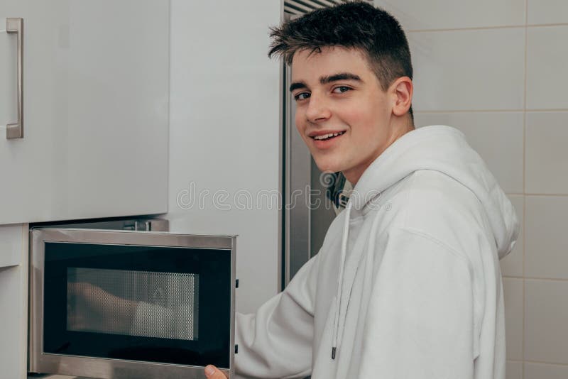 Young Man Manipulating the Microwave Stock Image - Image of house ...
