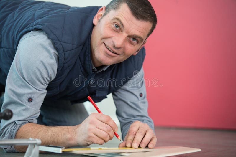 Young Man Marking Flooring with Pencil and Ruler Stock Photo - Image of ...