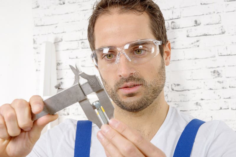 Young Man Measuring Using Caliper Stock Photo - Image of workshop, tool ...