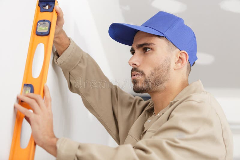 Young Man Measuring Wall with Level Stock Image - Image of drawing ...