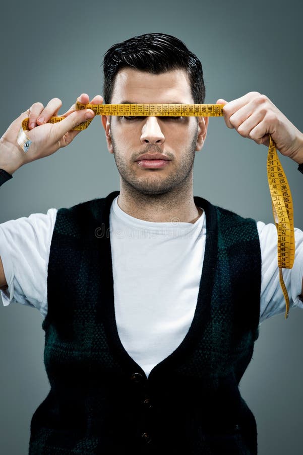 Young Man with a Metre Rule in Front of His Face Stock Image - Image of ...