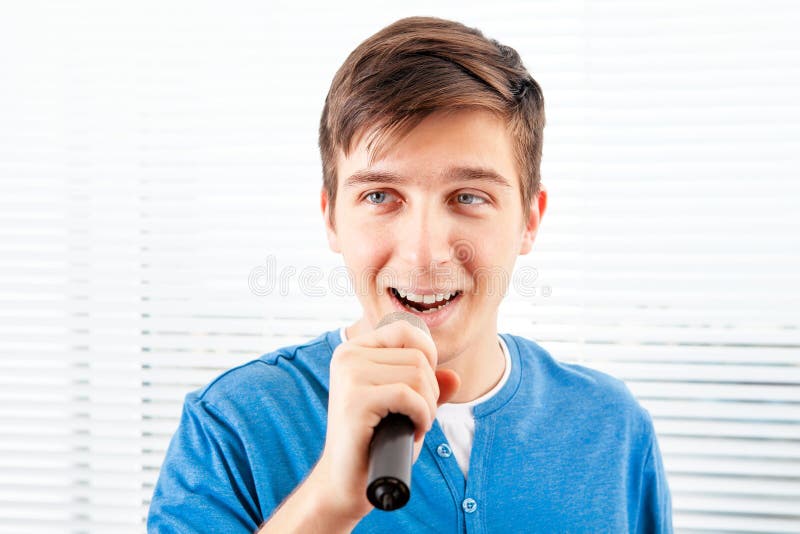 Young Man with a Microphone Stock Photo - Image of hand, closeup: 220067848