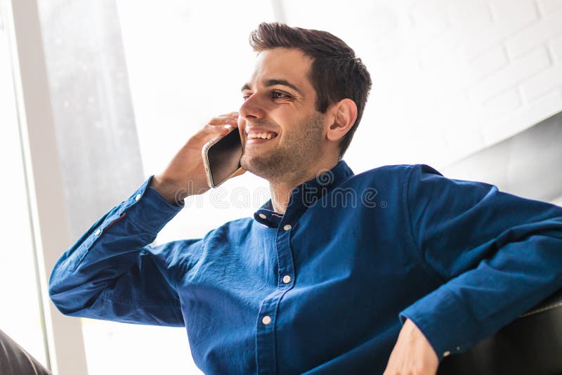 Young Man with Mobile Phone Stock Photo - Image of mobile, interior ...