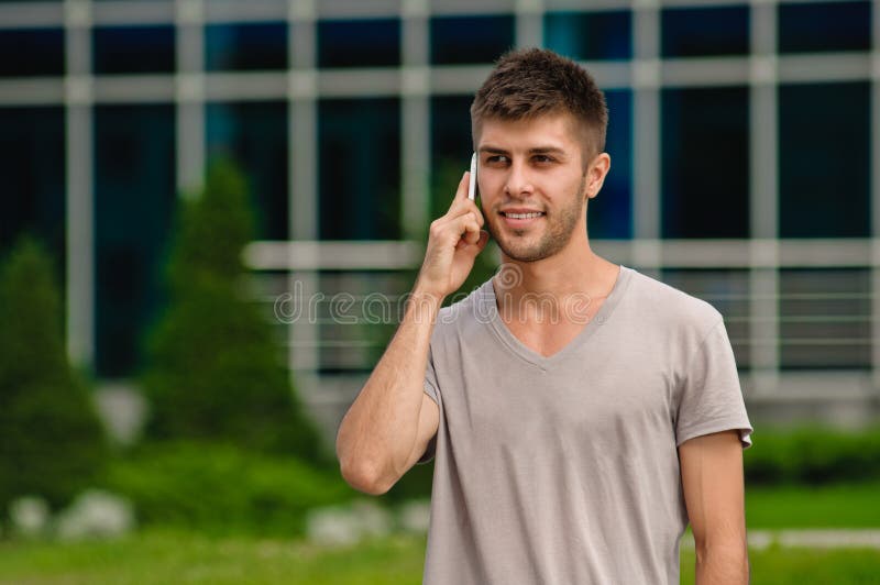 Young man and mobile phone stock image. Image of device - 41625123