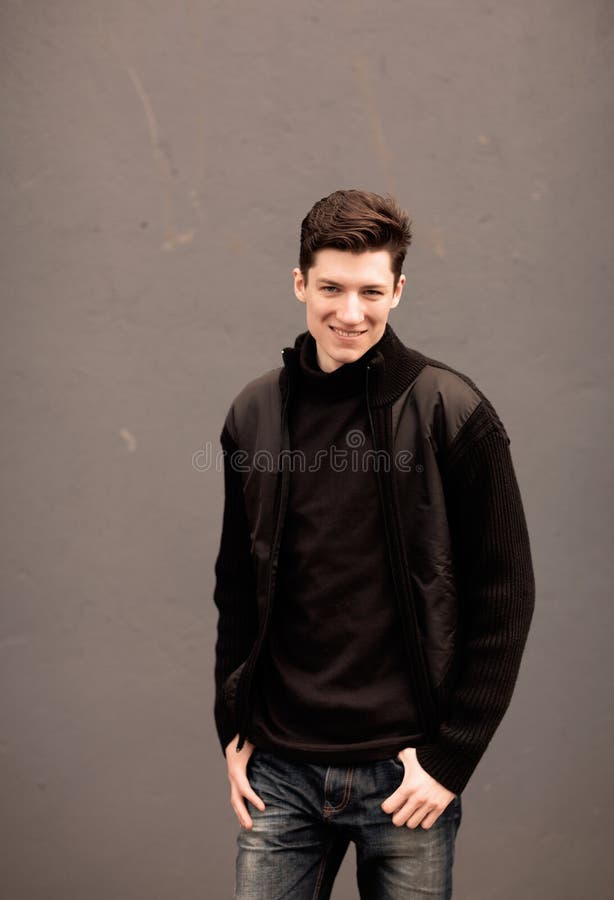 The Young Man Model in a Black Jacket Poses at a Wall. Image Toned ...