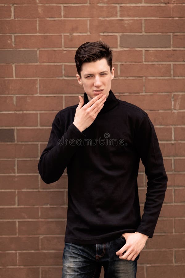The Young Man Model Poses at a Brick Wall. Toned Stock Photo - Image of ...