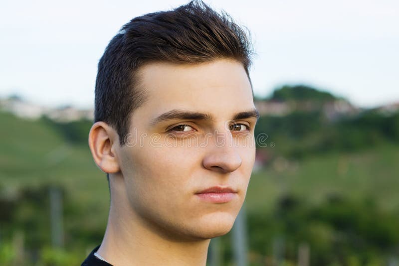 Young Man Model Seriously Looks into the Camera in the Evening Outdoor ...