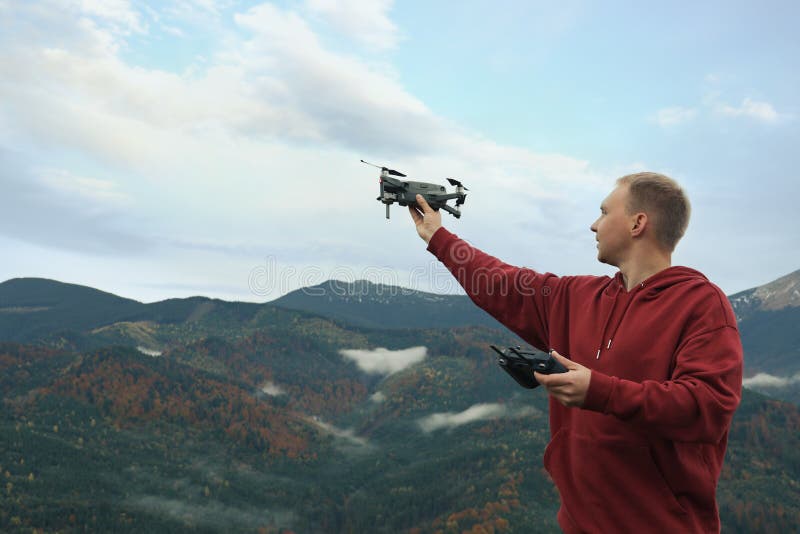 Young Man with Modern Drone in Mountains, Space for Text Stock Image ...
